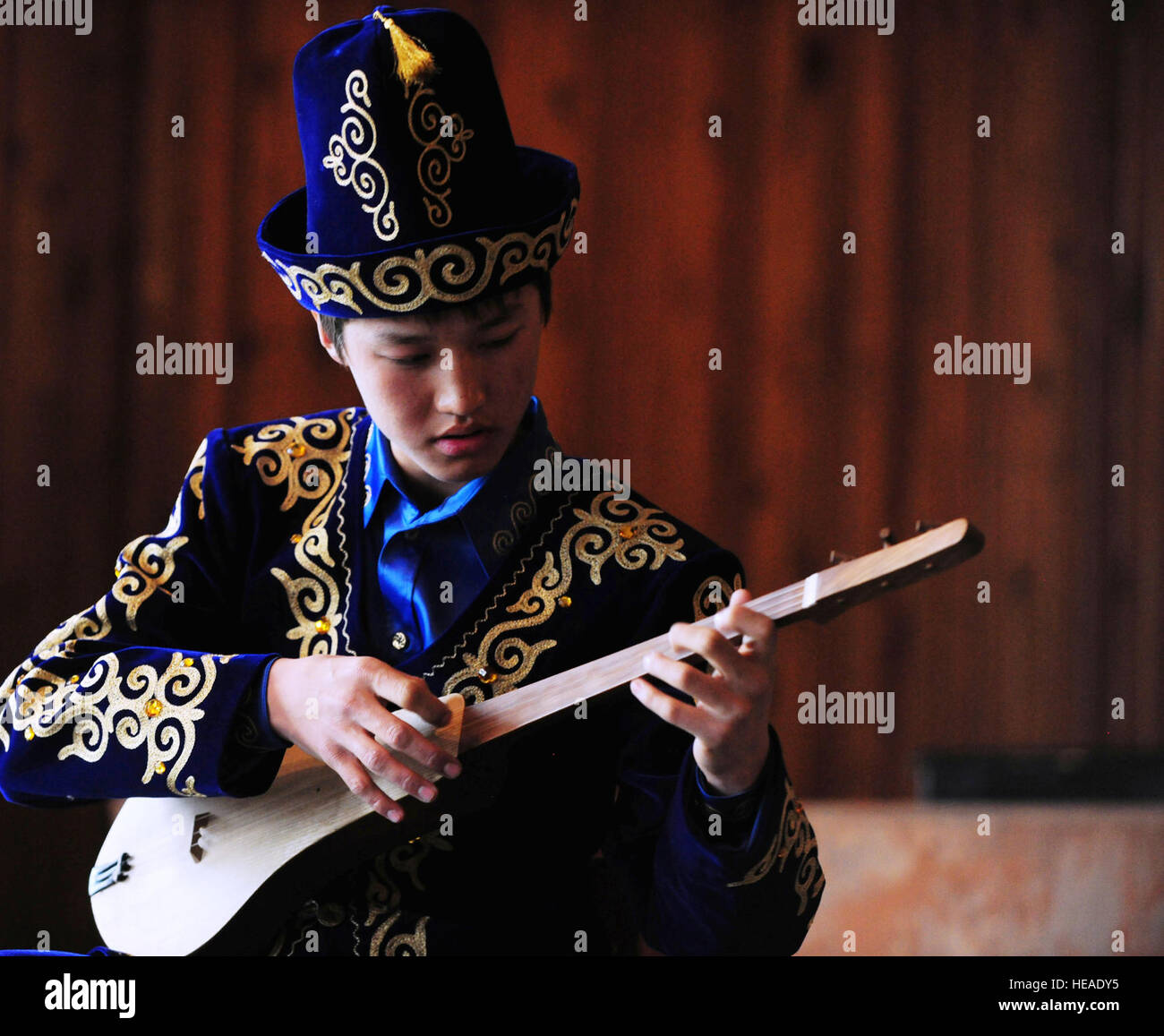 Kyrgyz students plays the Komuz, a local traditional instrument, for ...