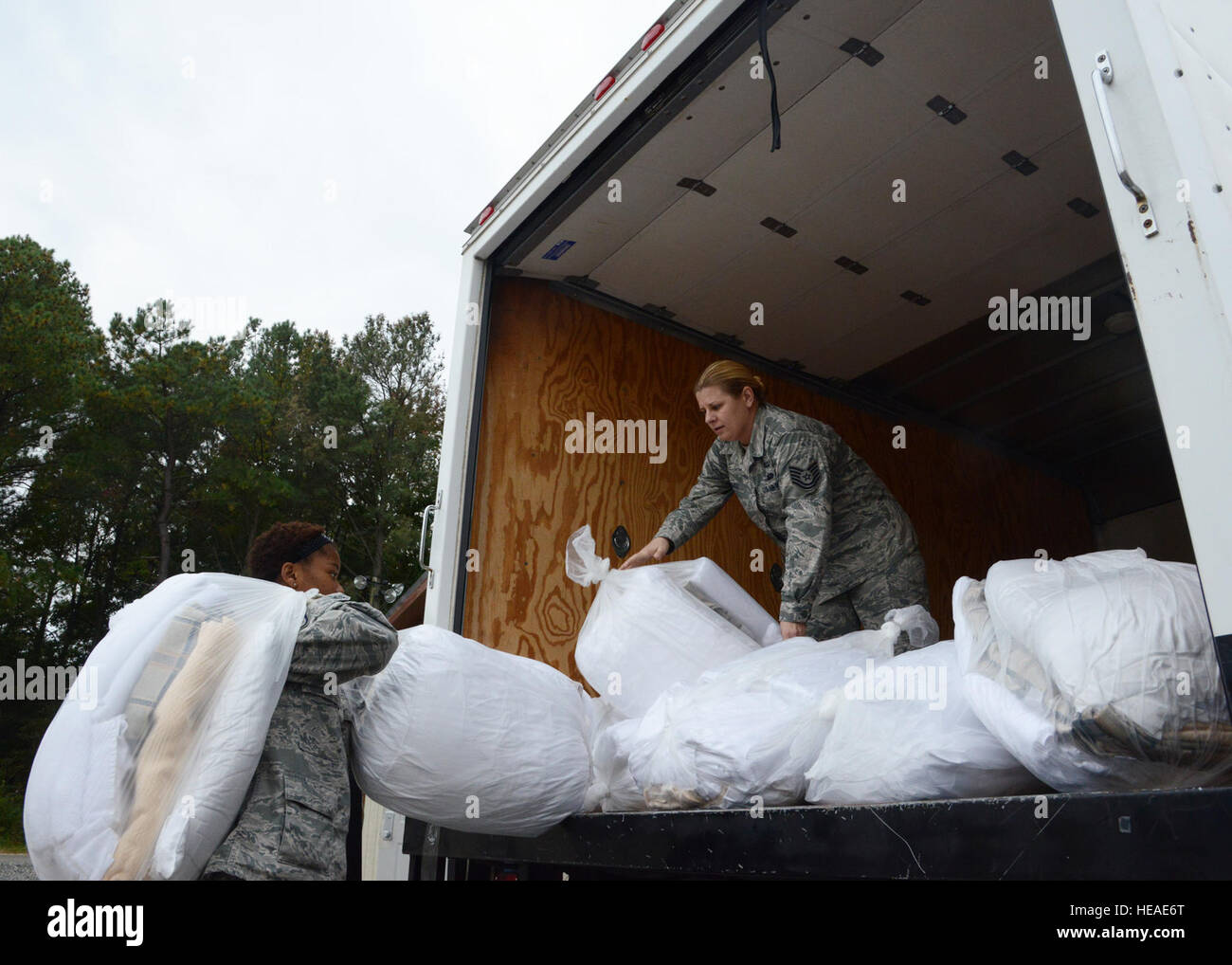 U.S. Air Force Airmen from the 633rd Air Base Wing unload fresh linens ...