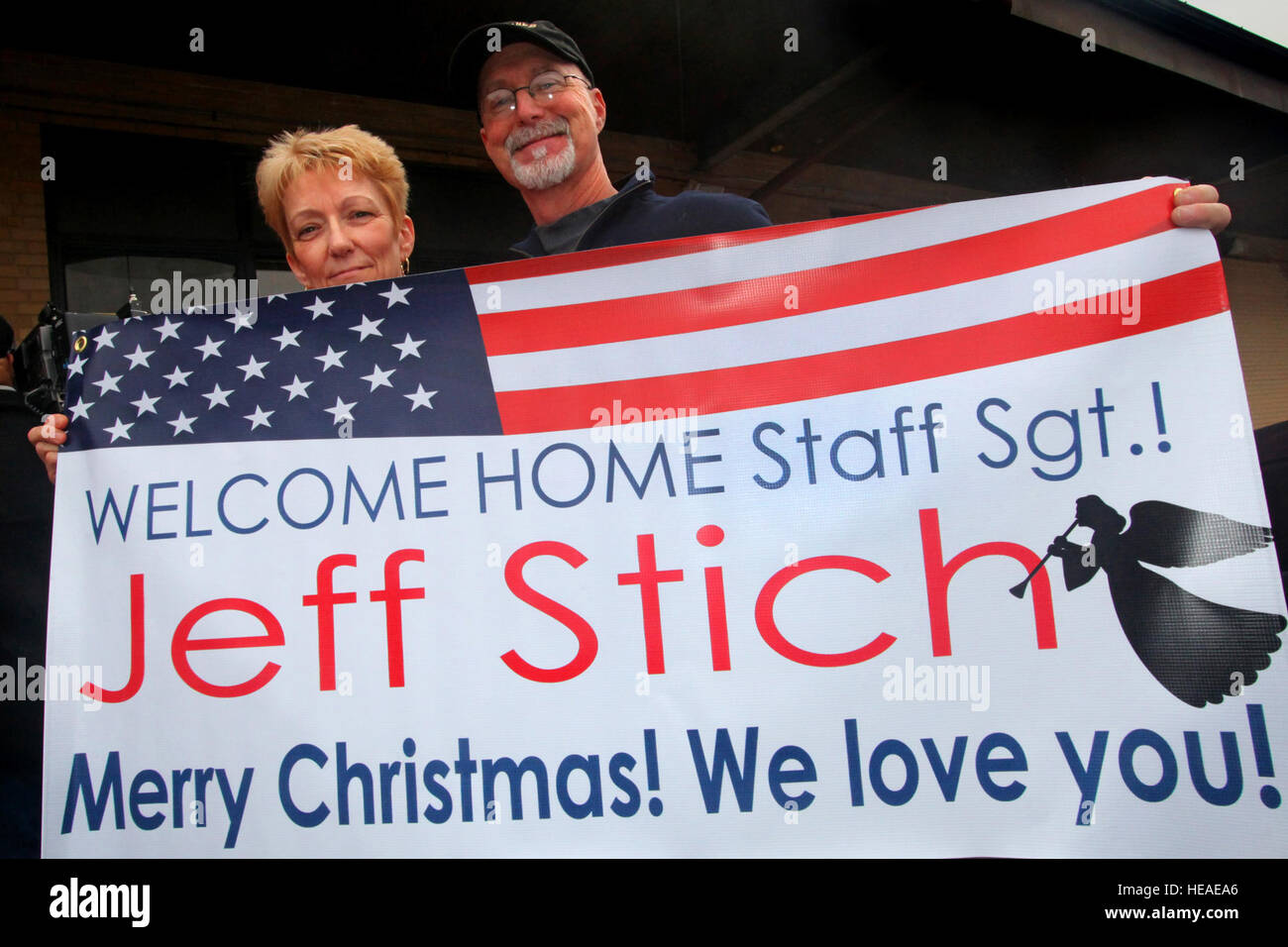 The parents of Staff Sgt. Jeff Stich proudly show off their sign ...