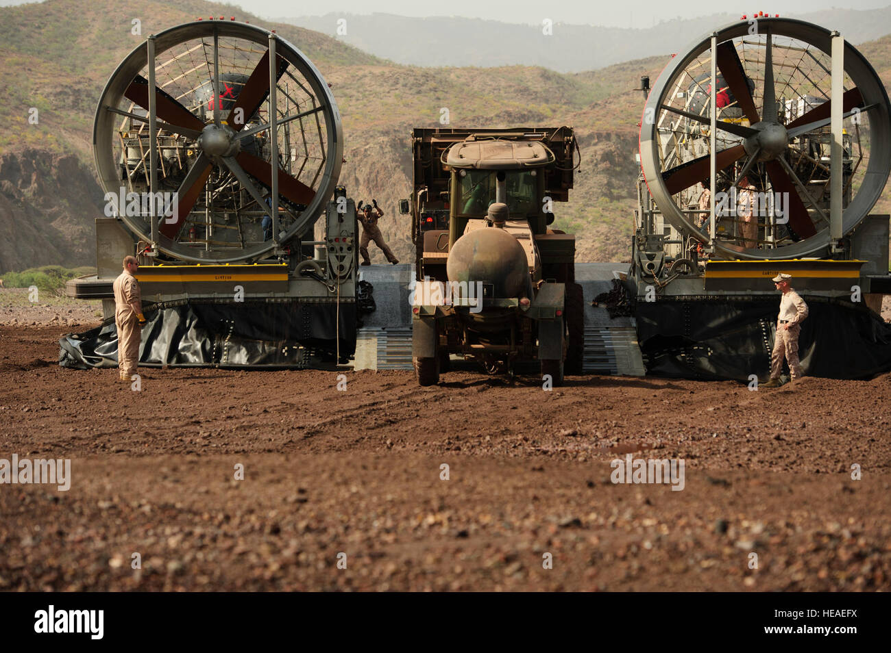 Tactical vehicles load onto a land craft, air cushioned vessel (LCAC ...