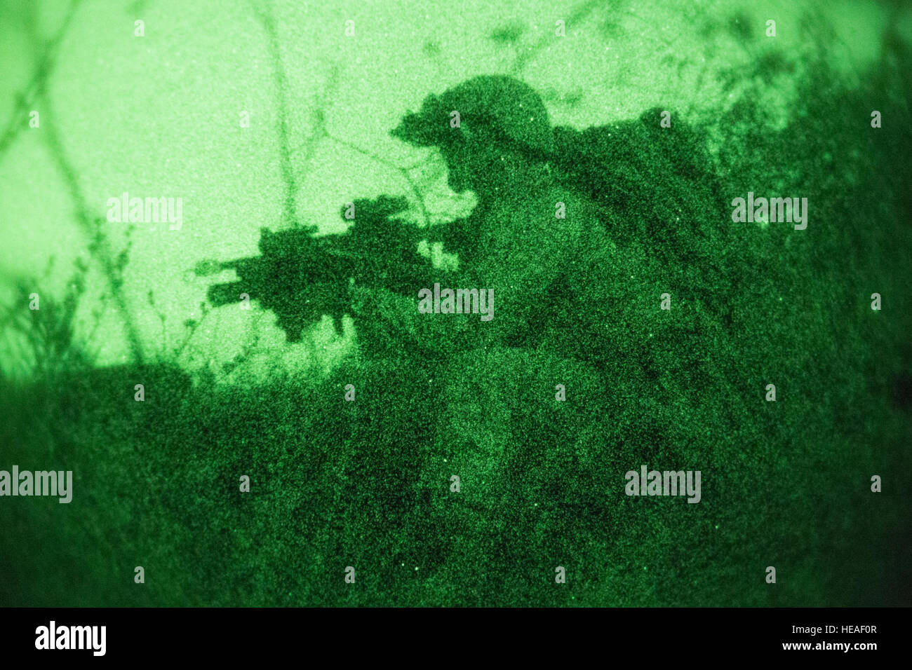 A Marine scouts a simulated enemy compound for hostile activity during ...