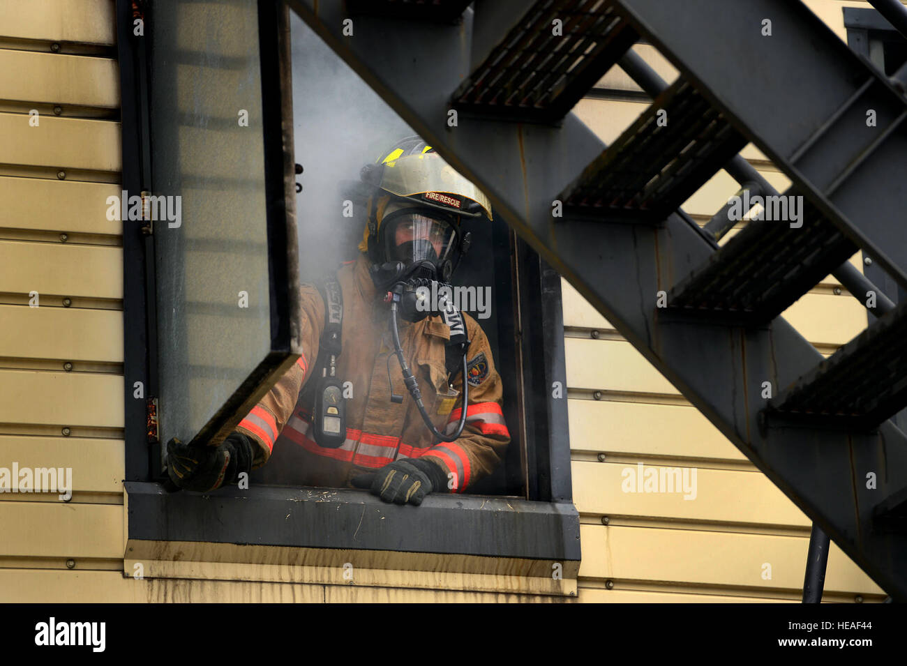 Senior Airman Clayton Angeloff opens a window on the structural burn ...