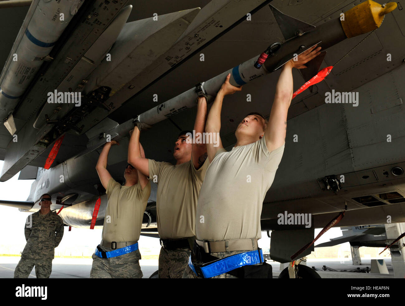A weapons load crew team from the 44th Aircraft Maintenance Unit work ...