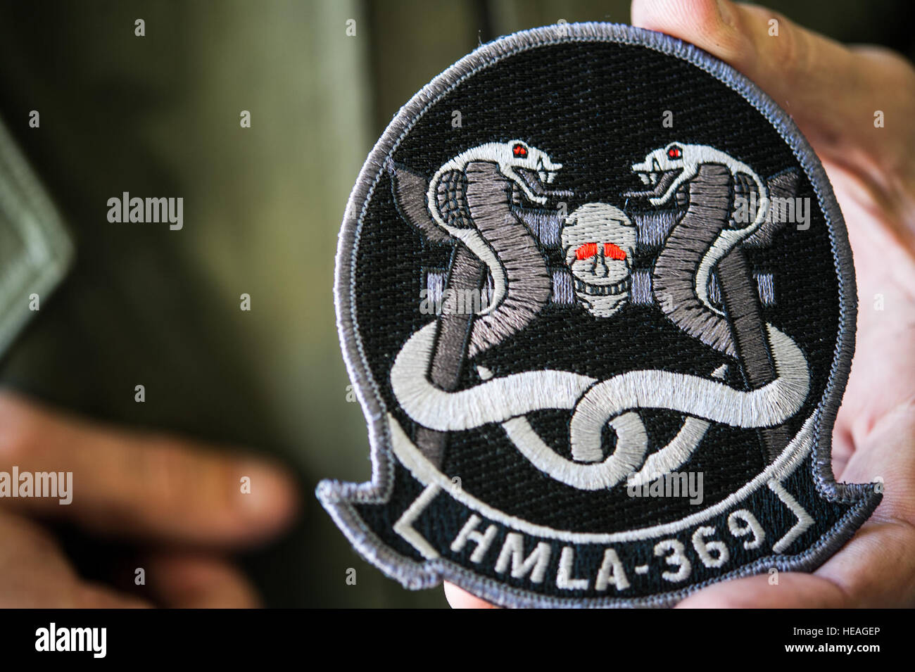 A U.S. Marine shows off the patch belonging to Marine Light Attack ...