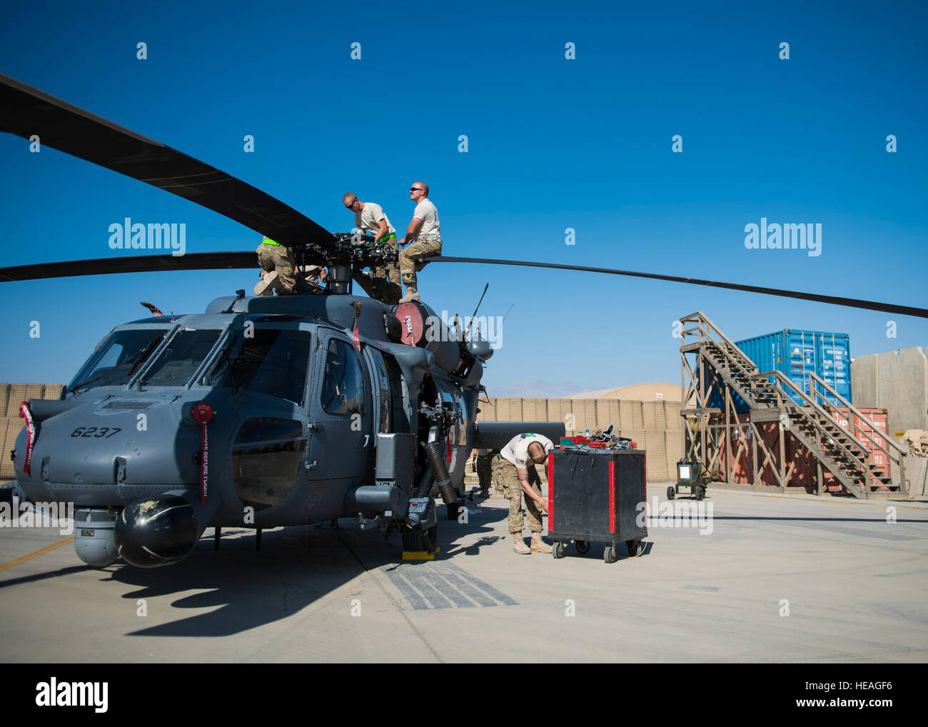 Airmen from the 83rd Expeditionary Rescue Squadron unfold the blades of ...