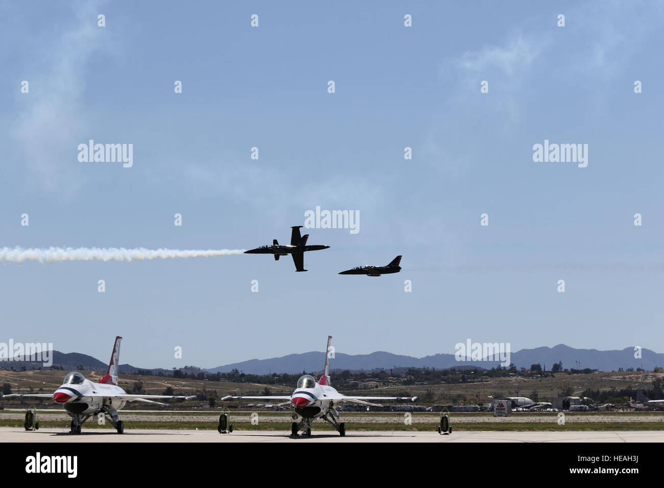 Members of the Patriots Jet Team perform maneuvers over the flight line ...