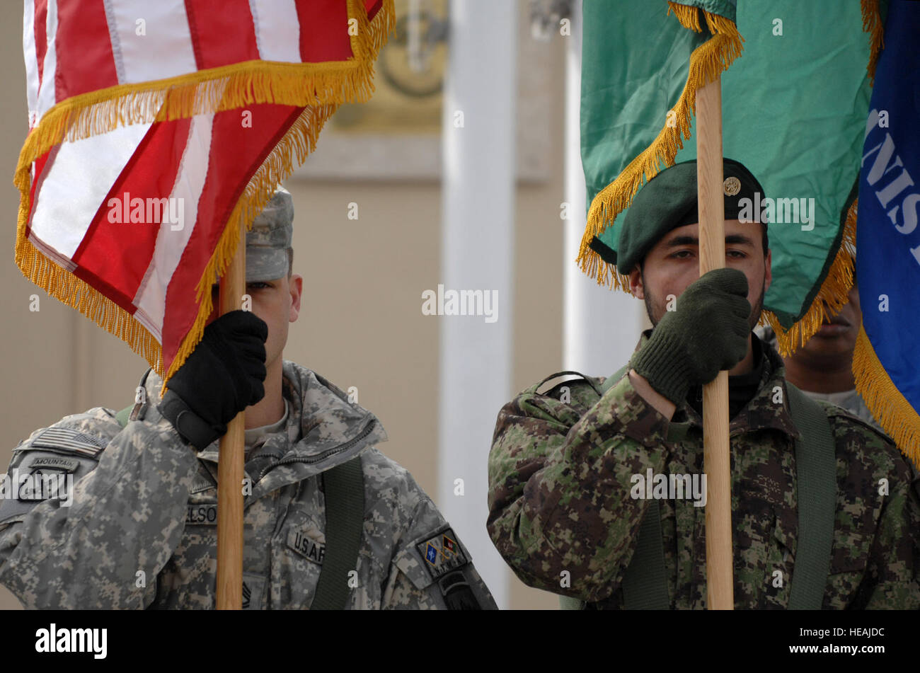 Members of a joint-service color guard detail await the arrival of the ...