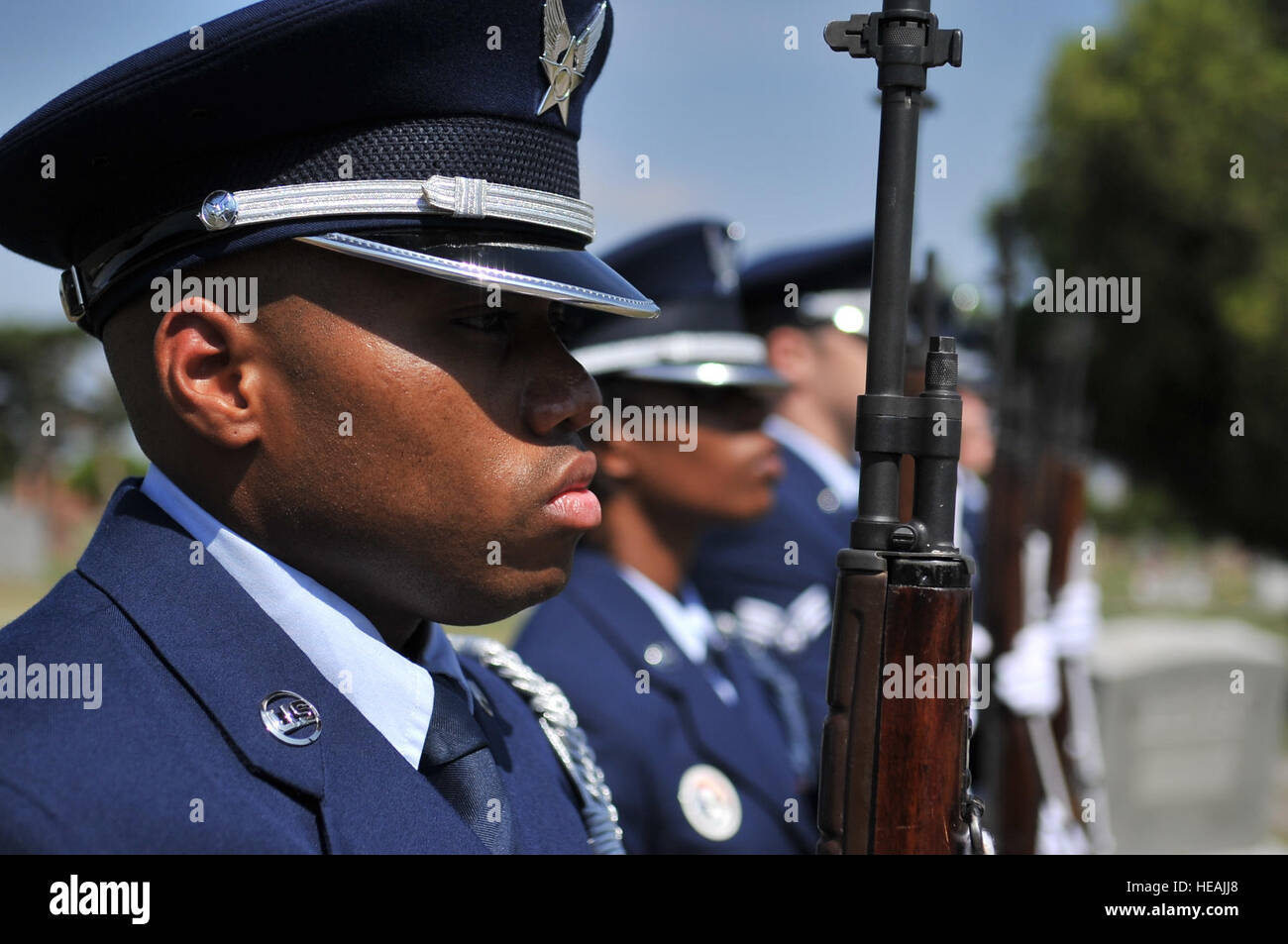 Altus Air Force Base Blue Knights honor guard members stand in a 21-gun salute formation during ...