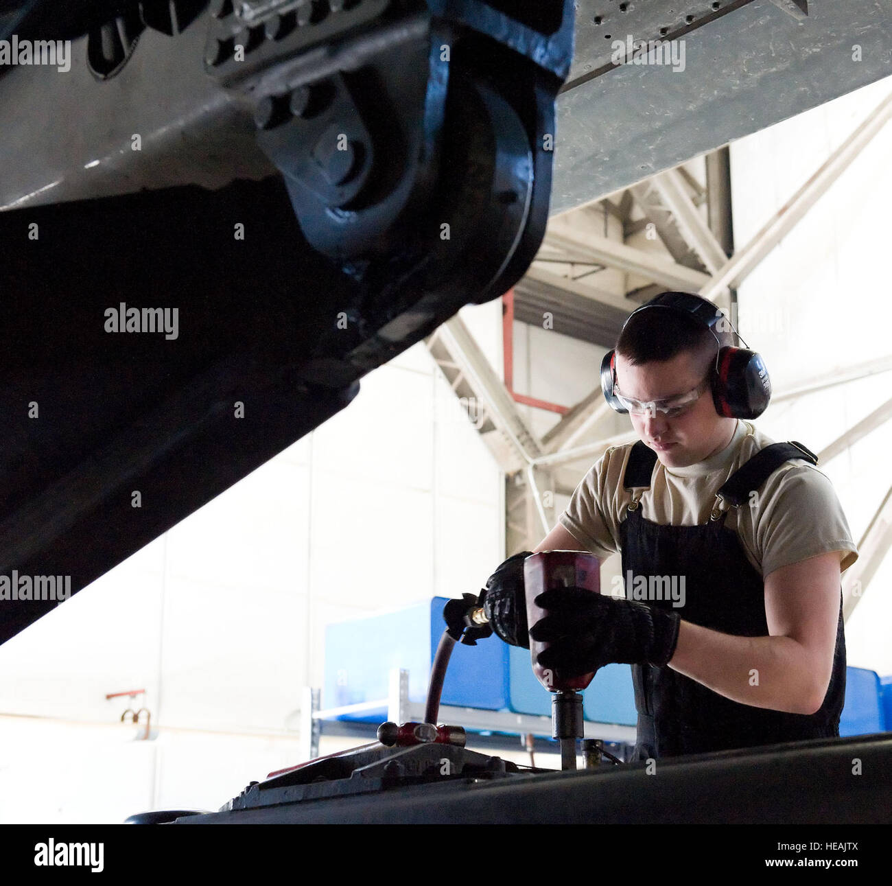 Air Force personnel perform maintenance on a Tunner 60K aircraft cargo ...