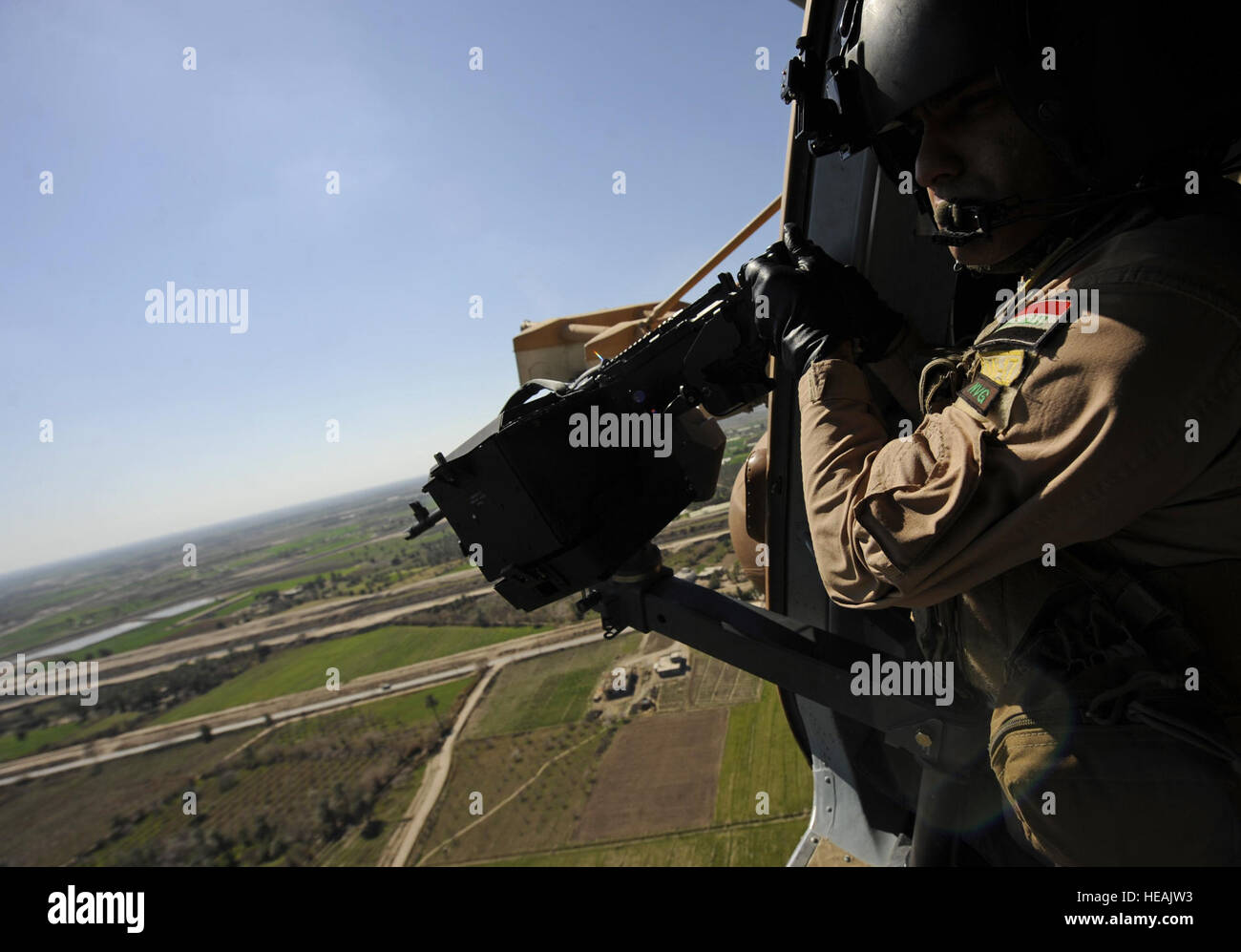 An Iraqi Army Aviation Command aerial gunner prepares to test fire his ...