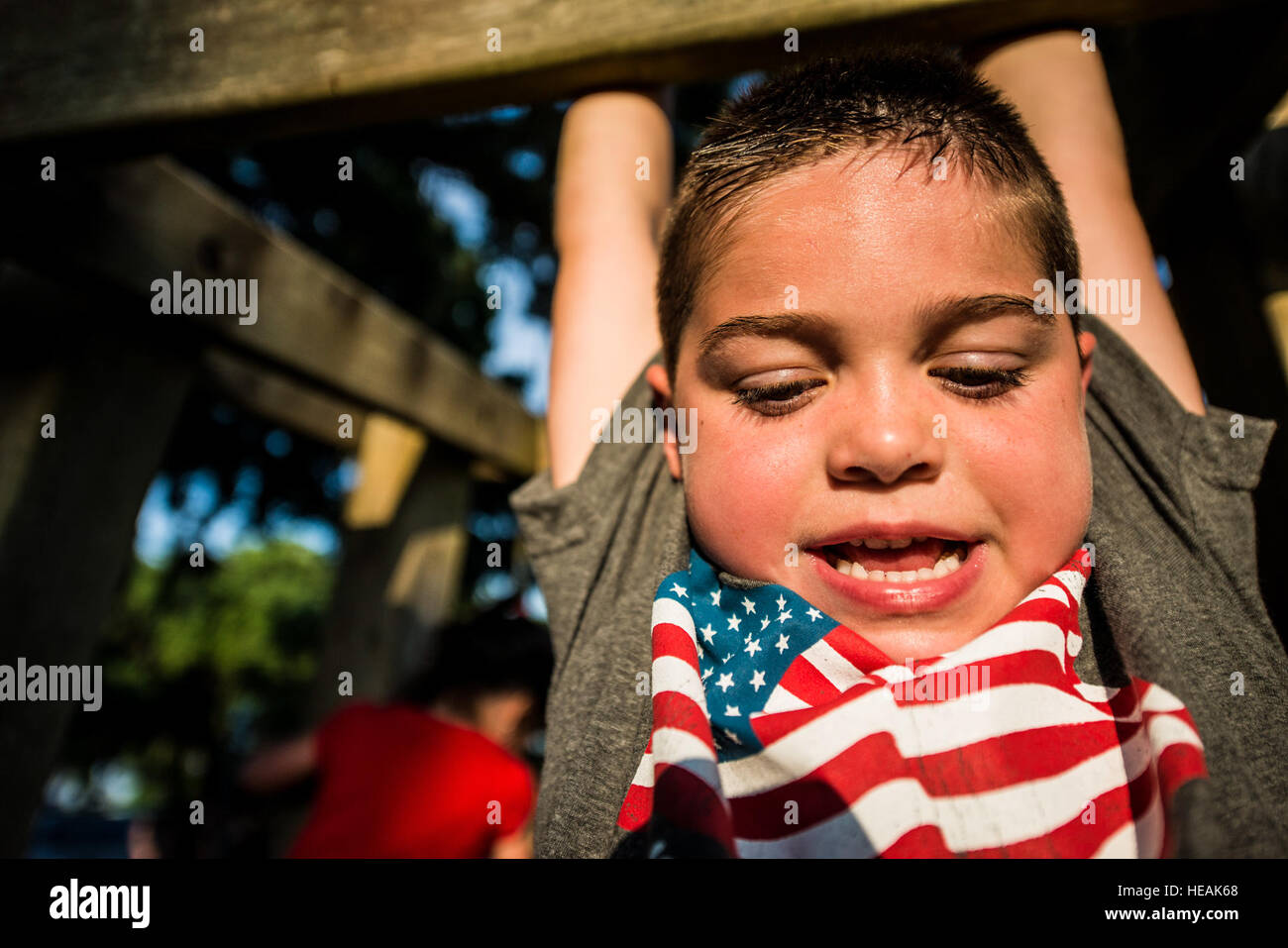 An Air Force military dependent plays on monkey bars during the 2013 ...