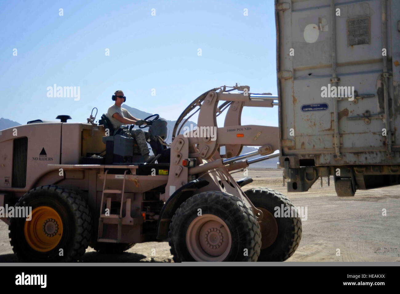 U.S. Air Force Russell P. Shemmell moves a connex box off the runway to ...