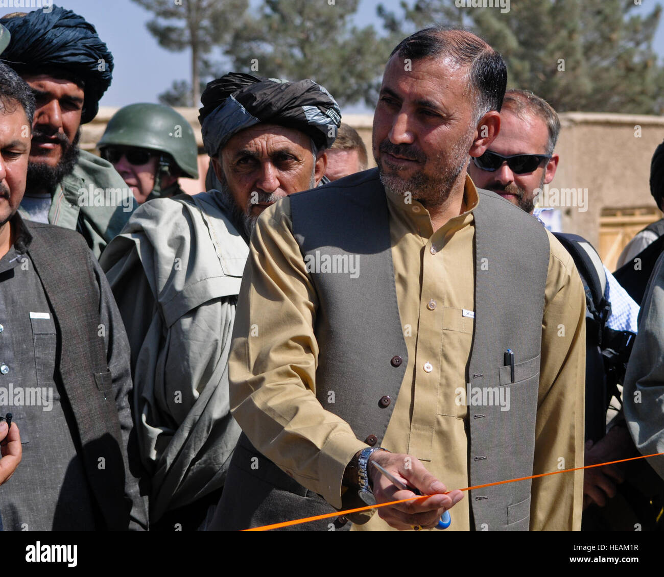 Uruzgan Provincial Governor Mohammed Sherzad prepares to cut the ribbon ...
