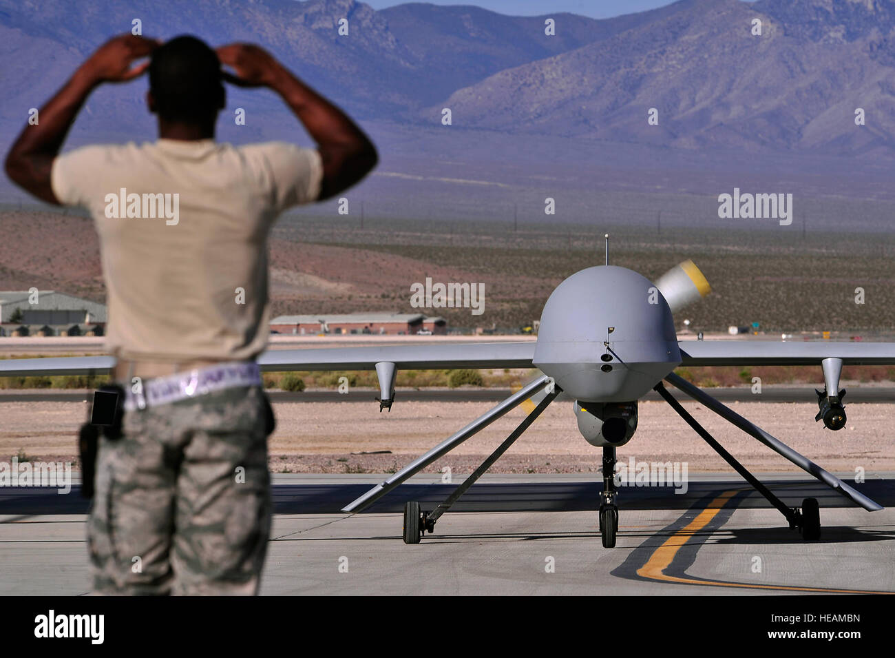 A dedicated crew chief marshals an MQ-1B Predator remotely piloted ...
