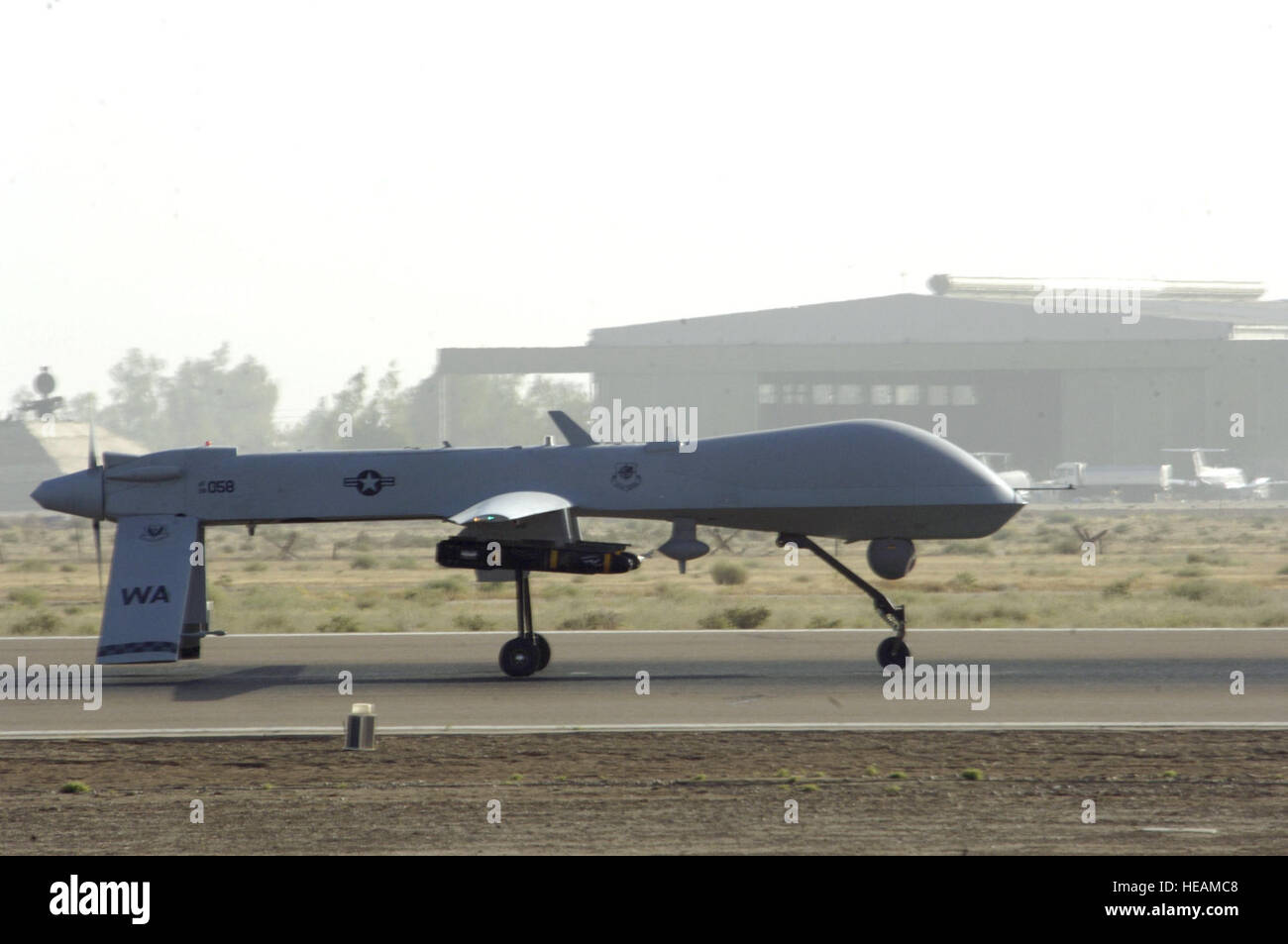 An MQ-1 Predator unmanned aerial vehicle taxis down the runway at Balad ...
