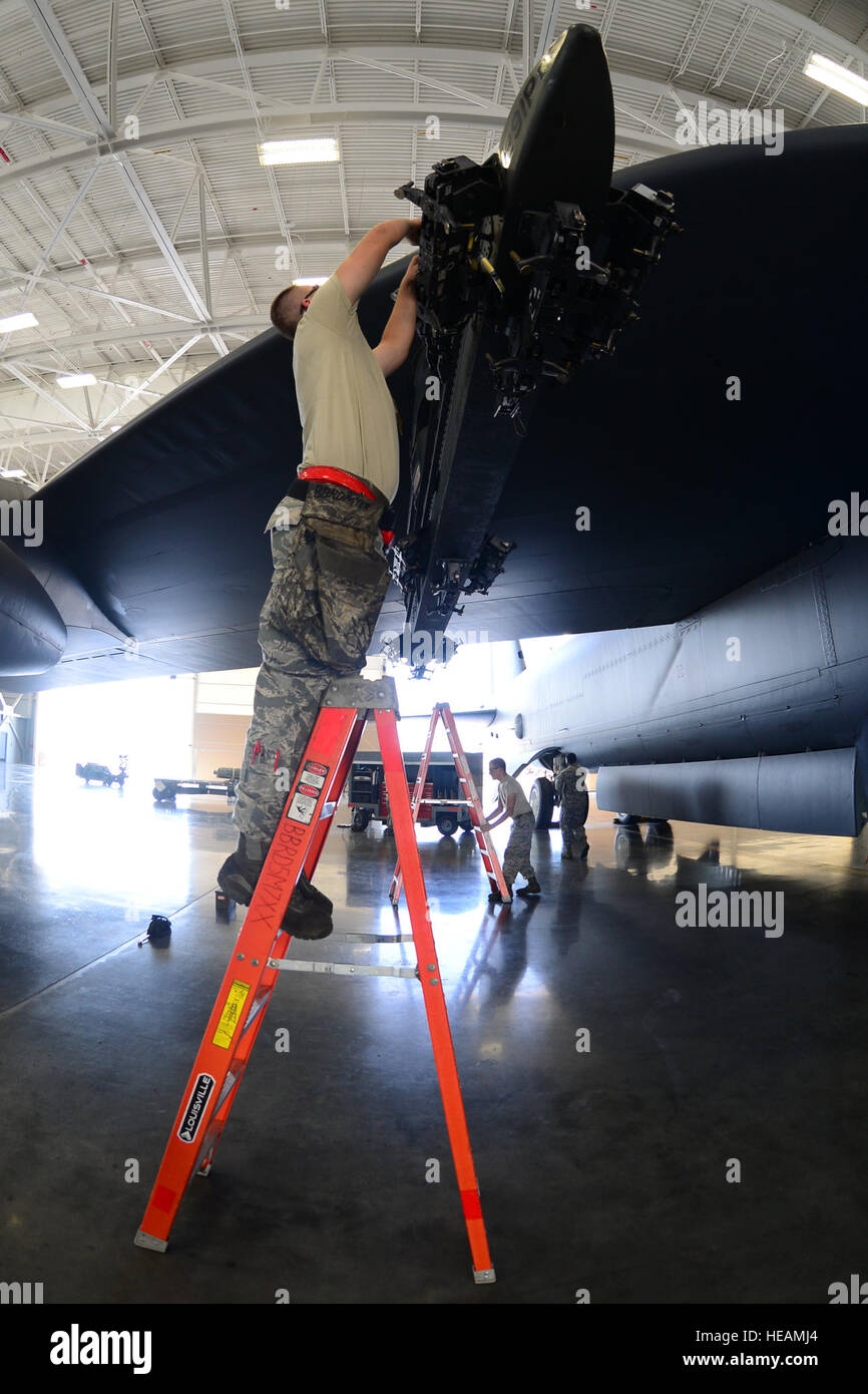 Airmen from the 2nd Aircraft Maintenance Squadron load CBU-103 ...