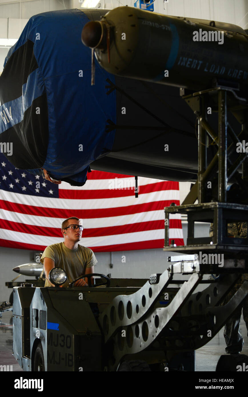 Air Force maintenance personnel maneuver a CBU-103 to mount on a B-52 ...
