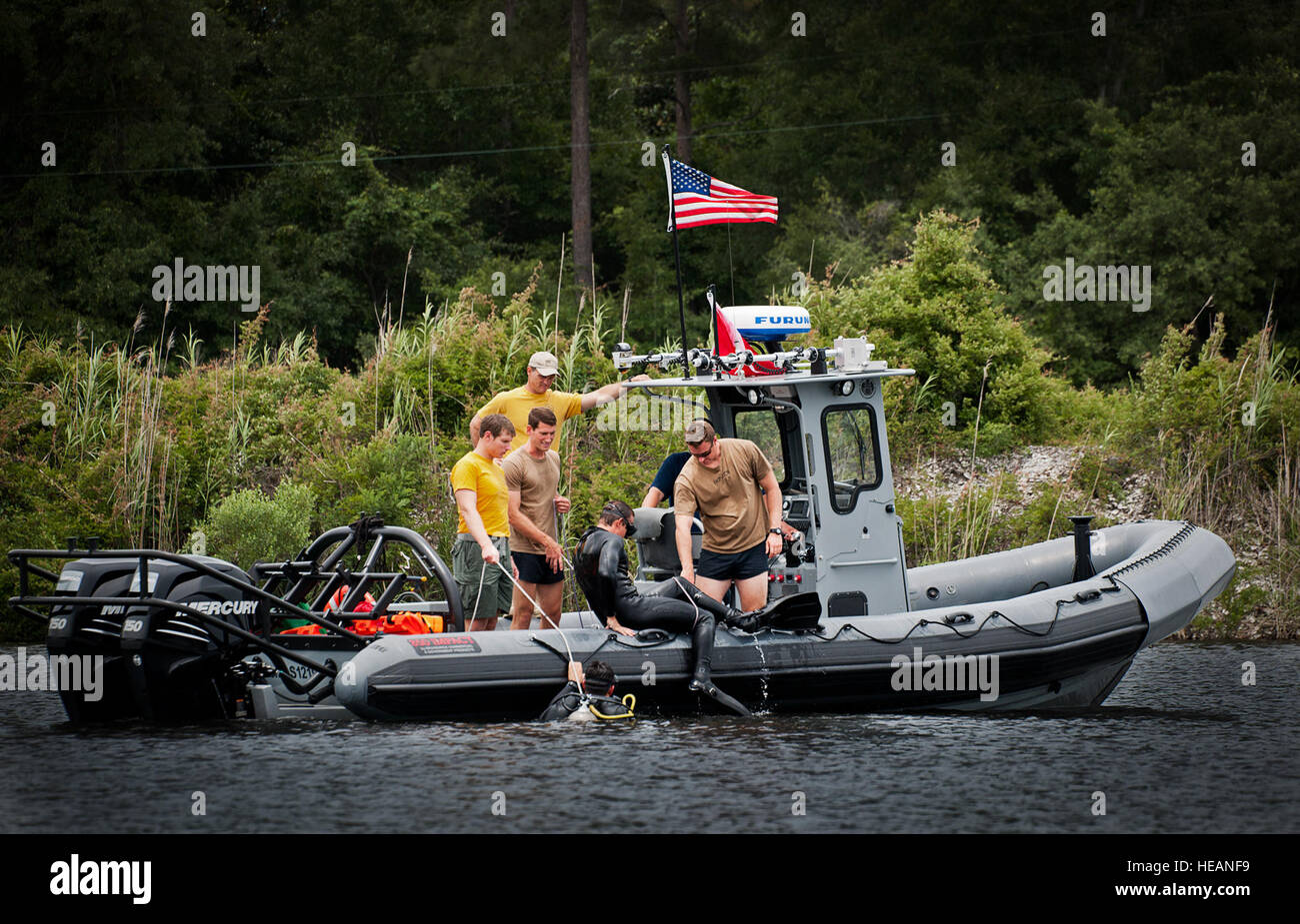 A Navy explosive ordnance disposal student climbs into a boat after a ...