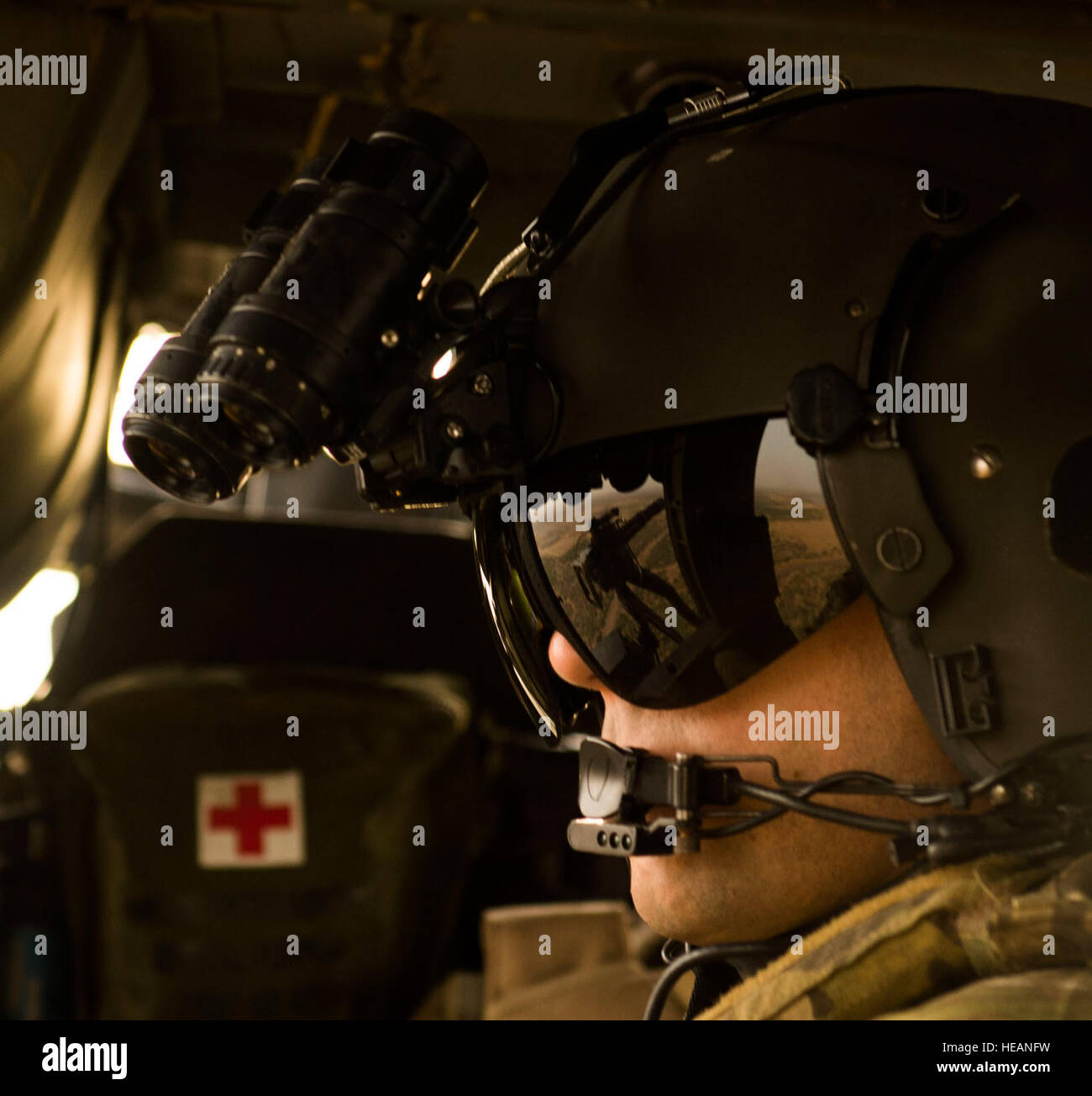 An aerial gunner with the 303rd Expeditionary Rescue Squadron looks out ...