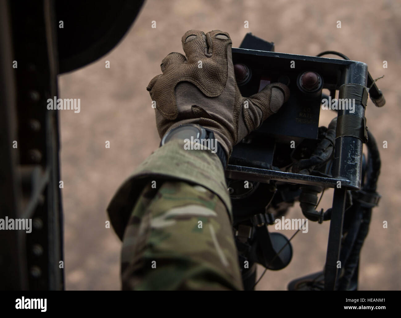 An aerial gunner with the 303rd Expeditionary Rescue Squadron arms his ...