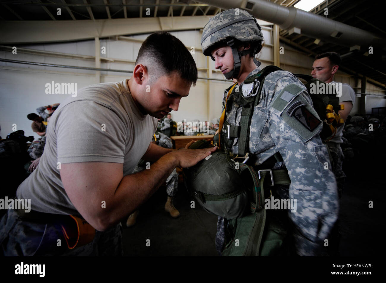 A jumpmaster conducts a gear check on U.S. Army 1st Lt. Maria Schwitz ...