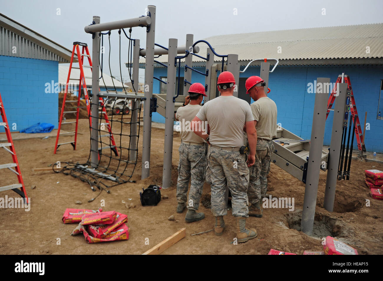 U.S. Airmen look over designs before starting the installation of the ...