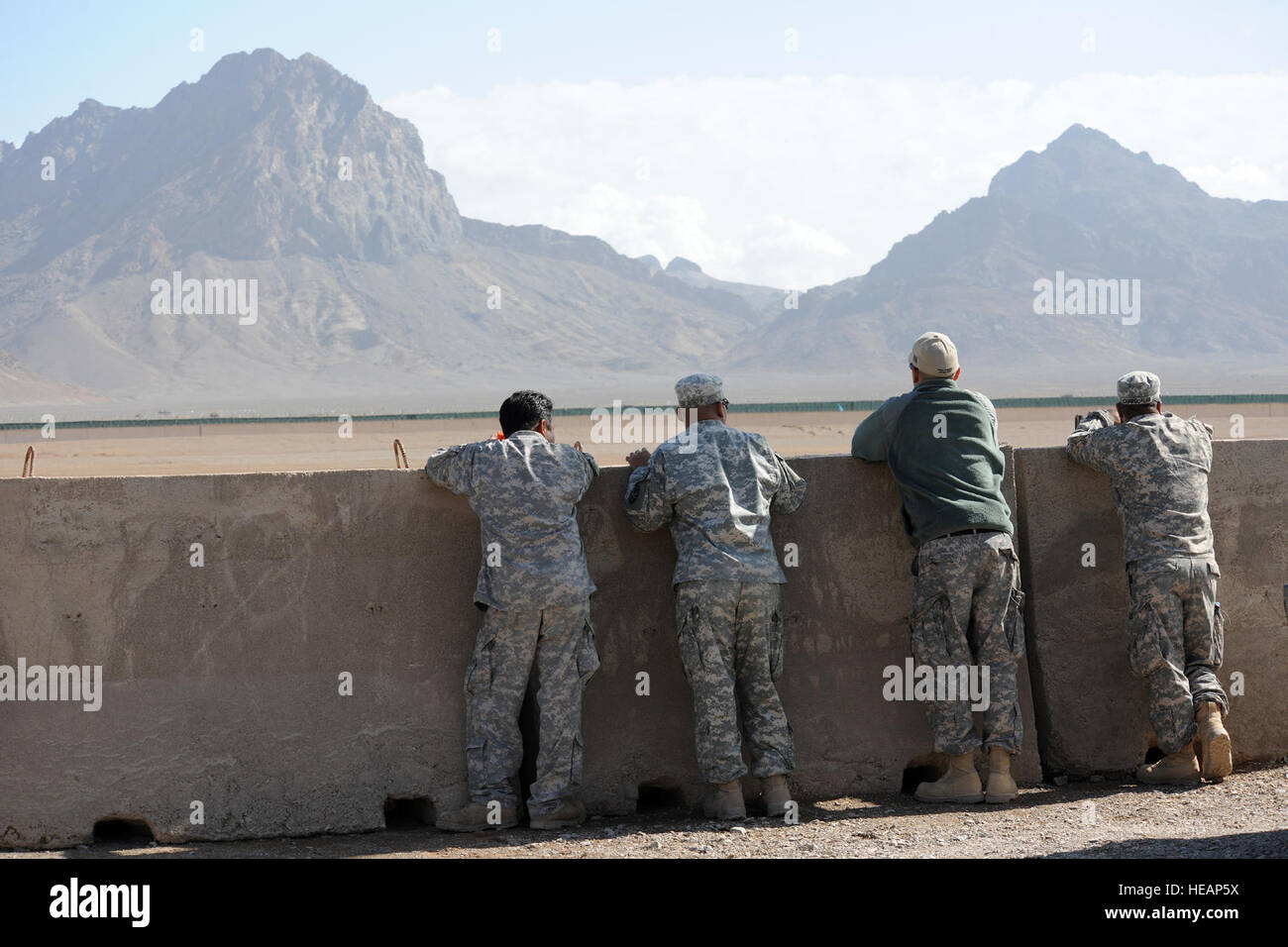 Four members of the outgoing Farah Provincial Reconstruction Team gaze ...