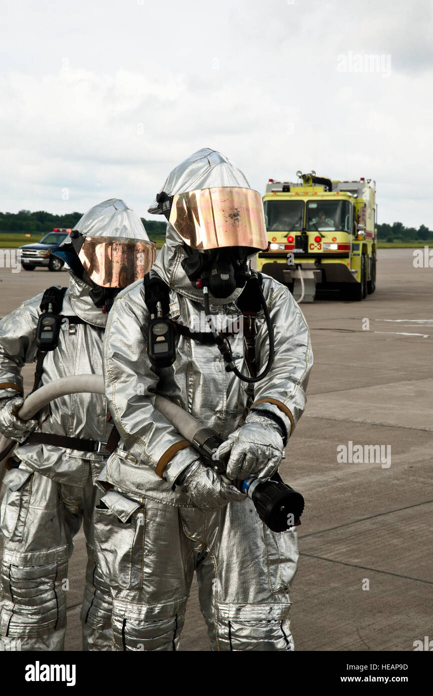 U.S. Air Force and civilian firefighters conduct a breach and enter ...