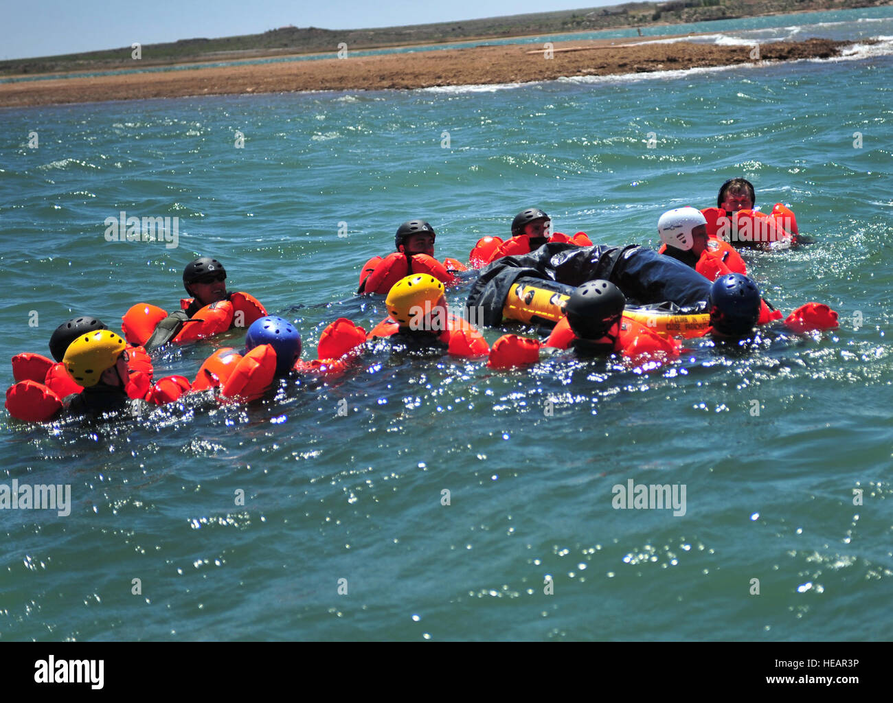 U.S. Air Force aircrew members gather around life rafts to learn proper ...