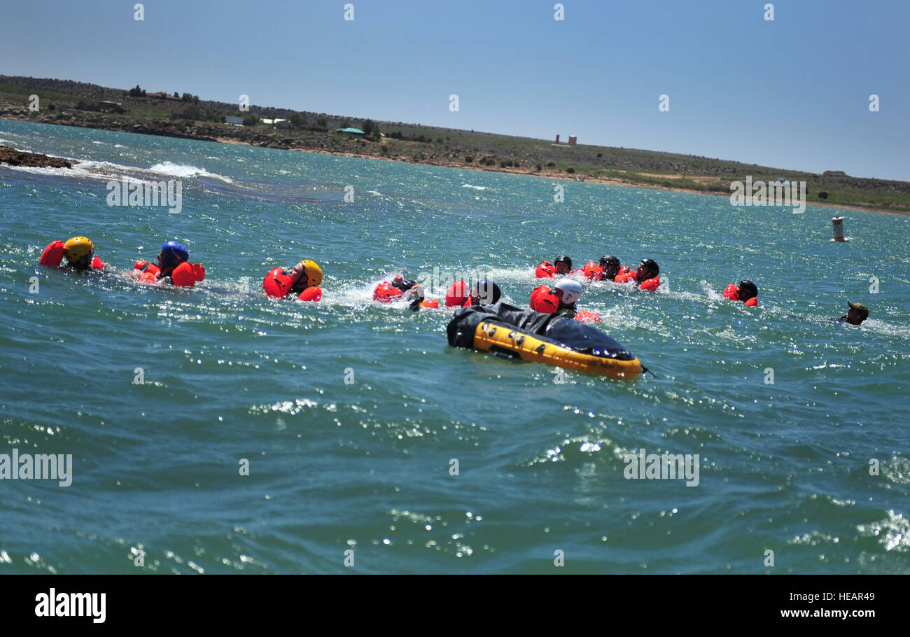 U.S. Air Force aircrew members struggle with currents near a life raft ...