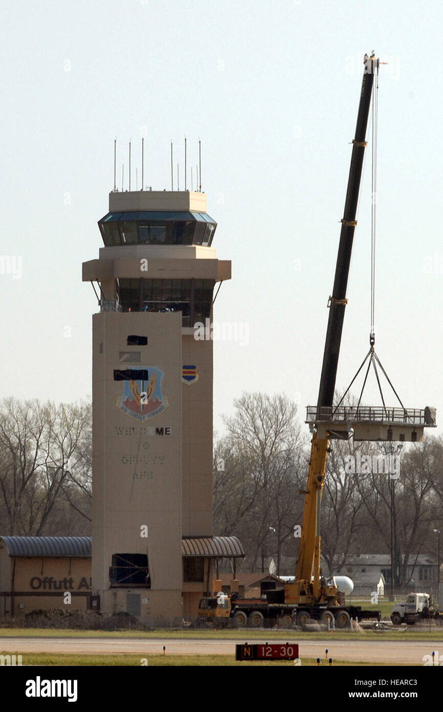 A crane prepares to remove a portion of the old air traffic control ...