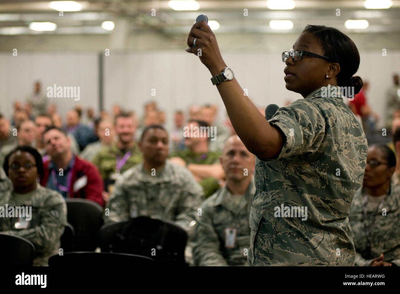 Military and multinational personnel receive a briefing on contracting ...
