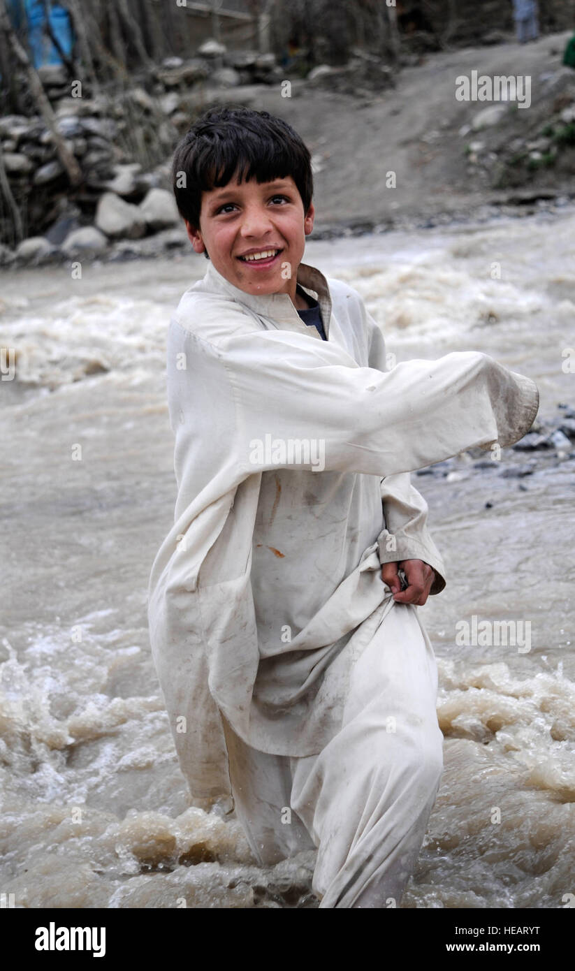 An Afghan boy smiles after crossing a river, April 18, 2009 Stock Photo ...