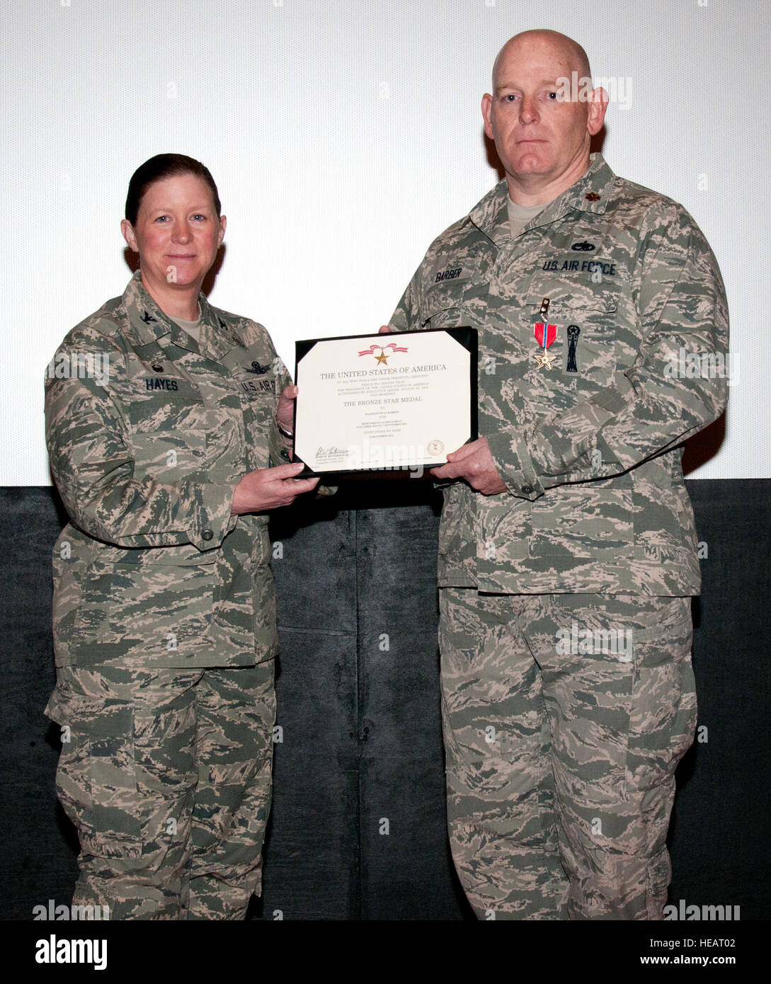 Col. Tracey Hayes, 90th Missile Wing commander, presents Maj. Kevin ...