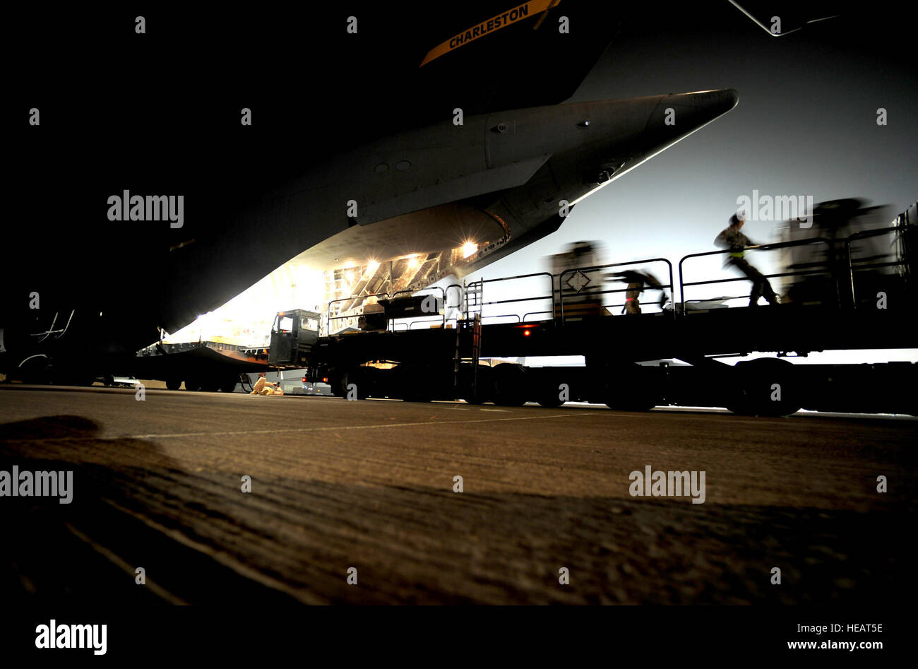 Airmen from the 8th Expeditionary Aircraft Mobility Squadron loaded a C ...