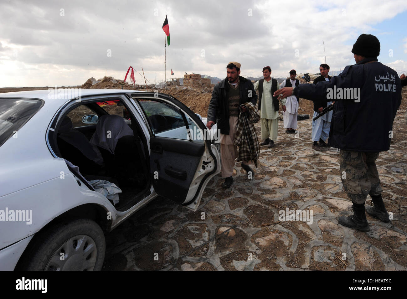 Afghan border police officers conduct a vehicle search at checkpoint 4 ...