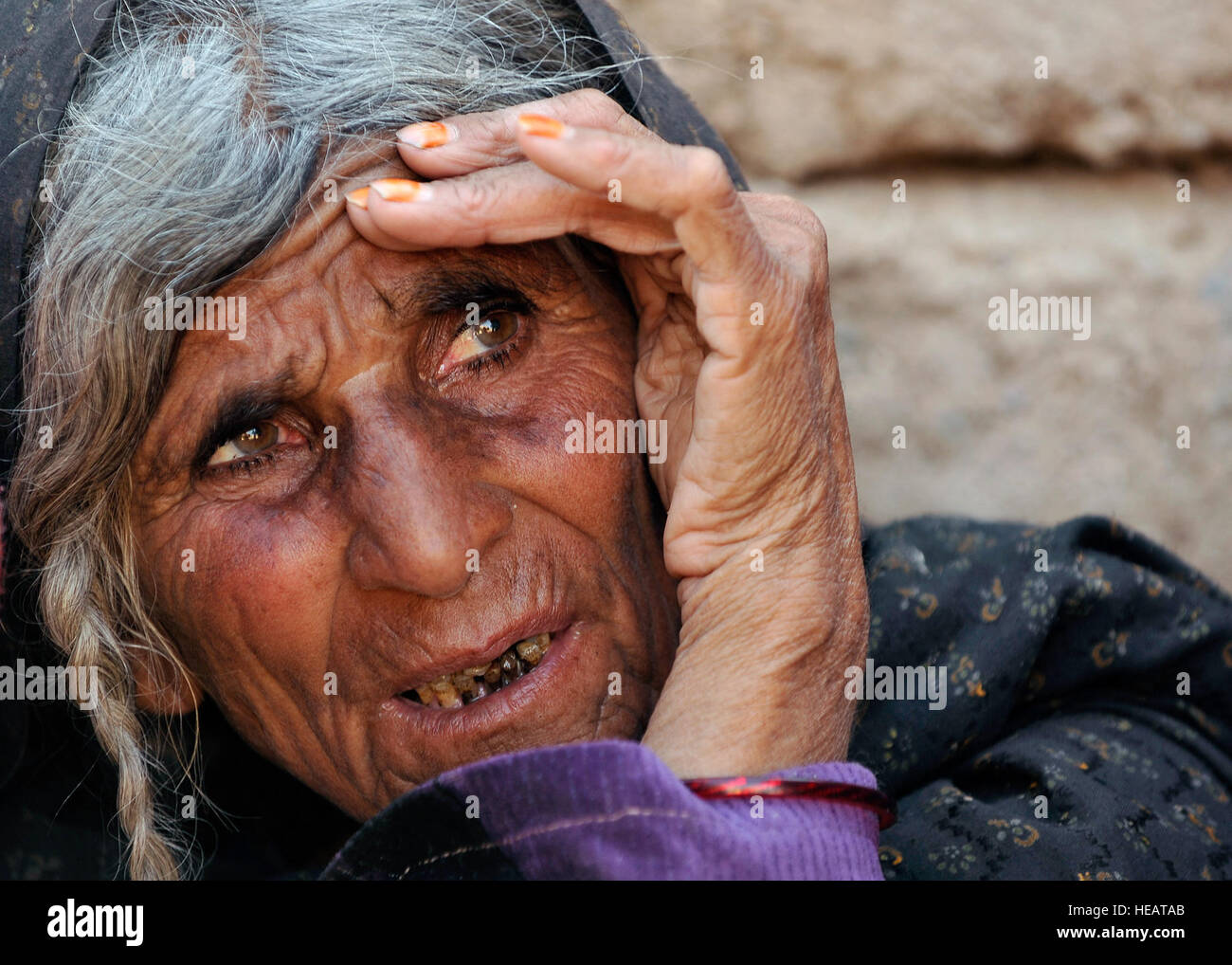 An elderly woman observes medics with Charlie Company, 402nd Brigade ...