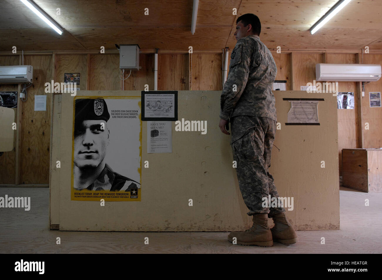 U.S. Army Pvt. Andrew Lay waits for a computer to check his email ...