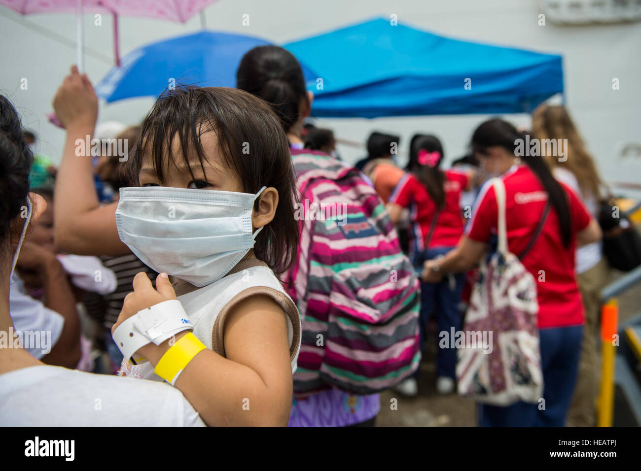 SUBIC BAY, Philippines (Aug. 8, 2015) A Filipino girl waits to board ...