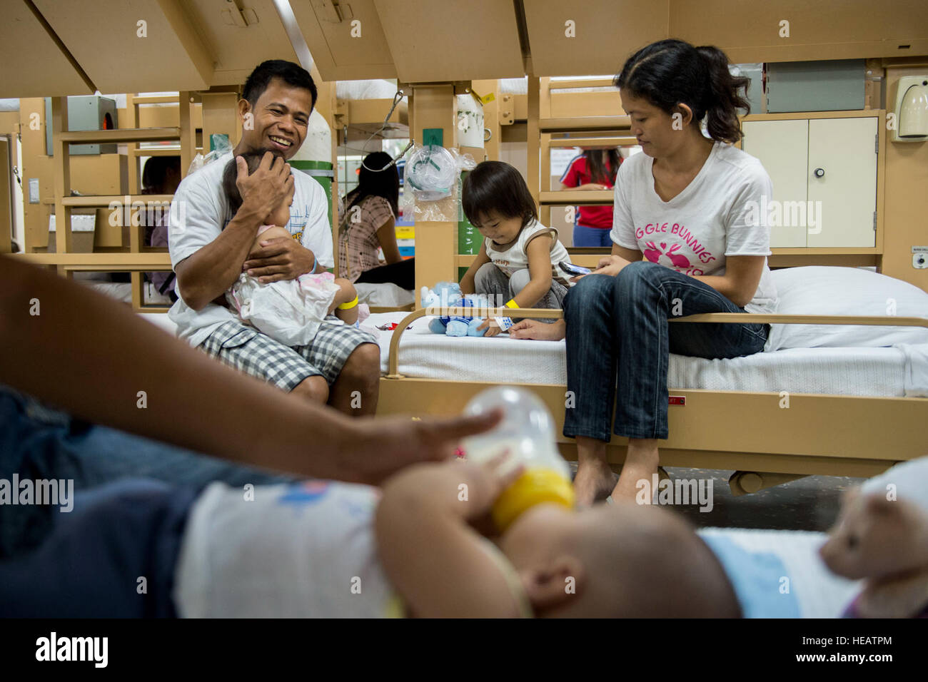 SUBIC BAY, Philippines (Aug. 8, 2015) A Filipino family sits in a pre ...