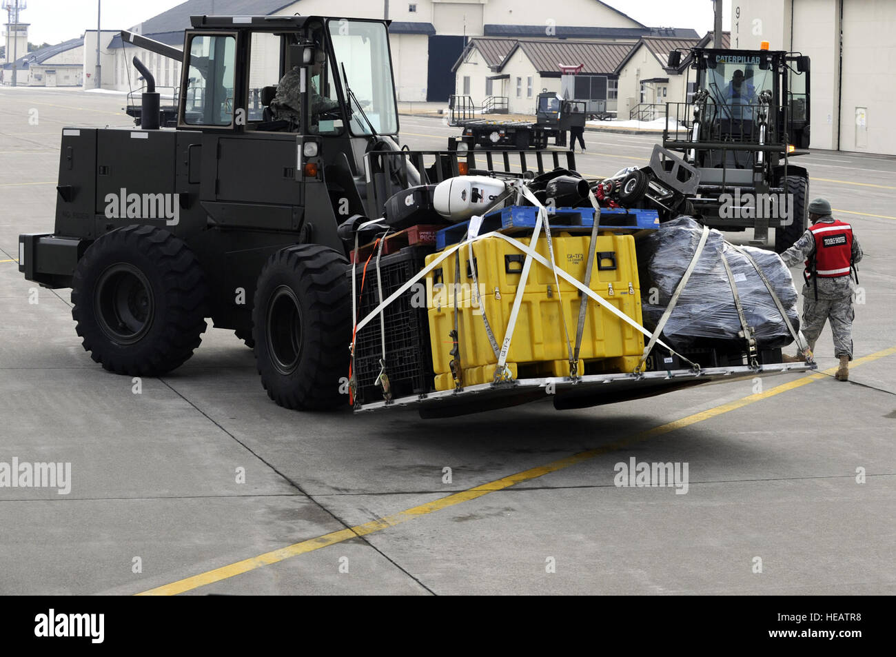 An U.S. Air Force forklift transports pallets from a Los Angeles Search ...