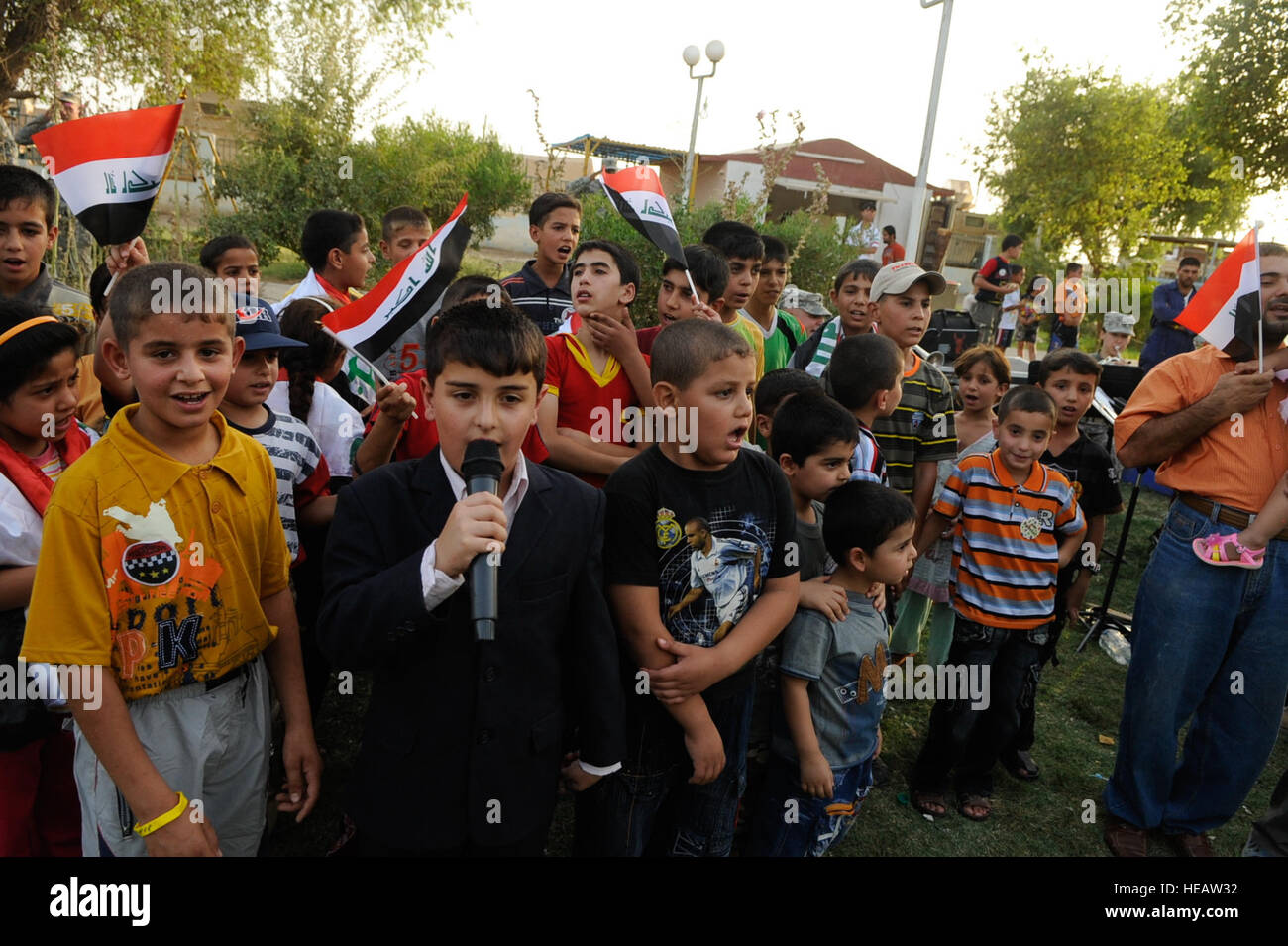 An Iraqi boy sings the Iraqi national anthem at Al Thobad Park, in Al ...