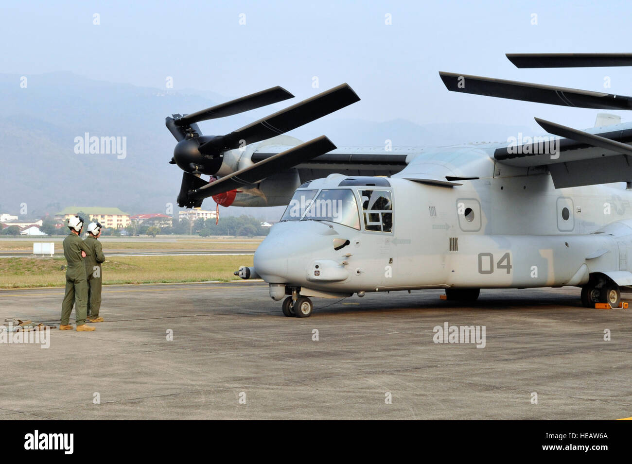 U.S. Marine Corps MV-22B Osprey crew chiefs perform pre-flight checks ...