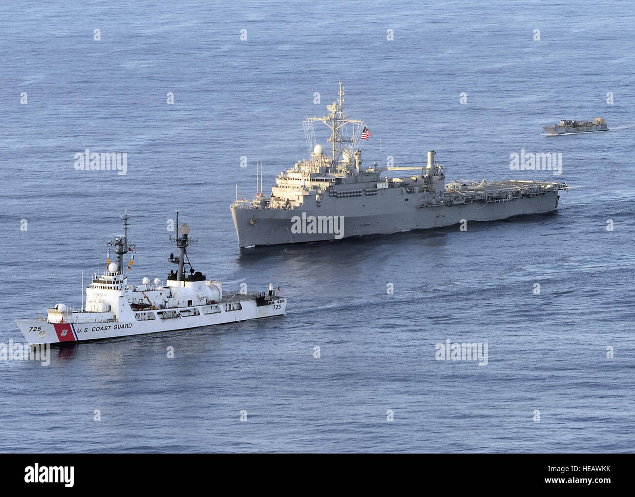 The U.S. Coast Guard cutter Jarvis (WHEC-725), front, the amphibious ...
