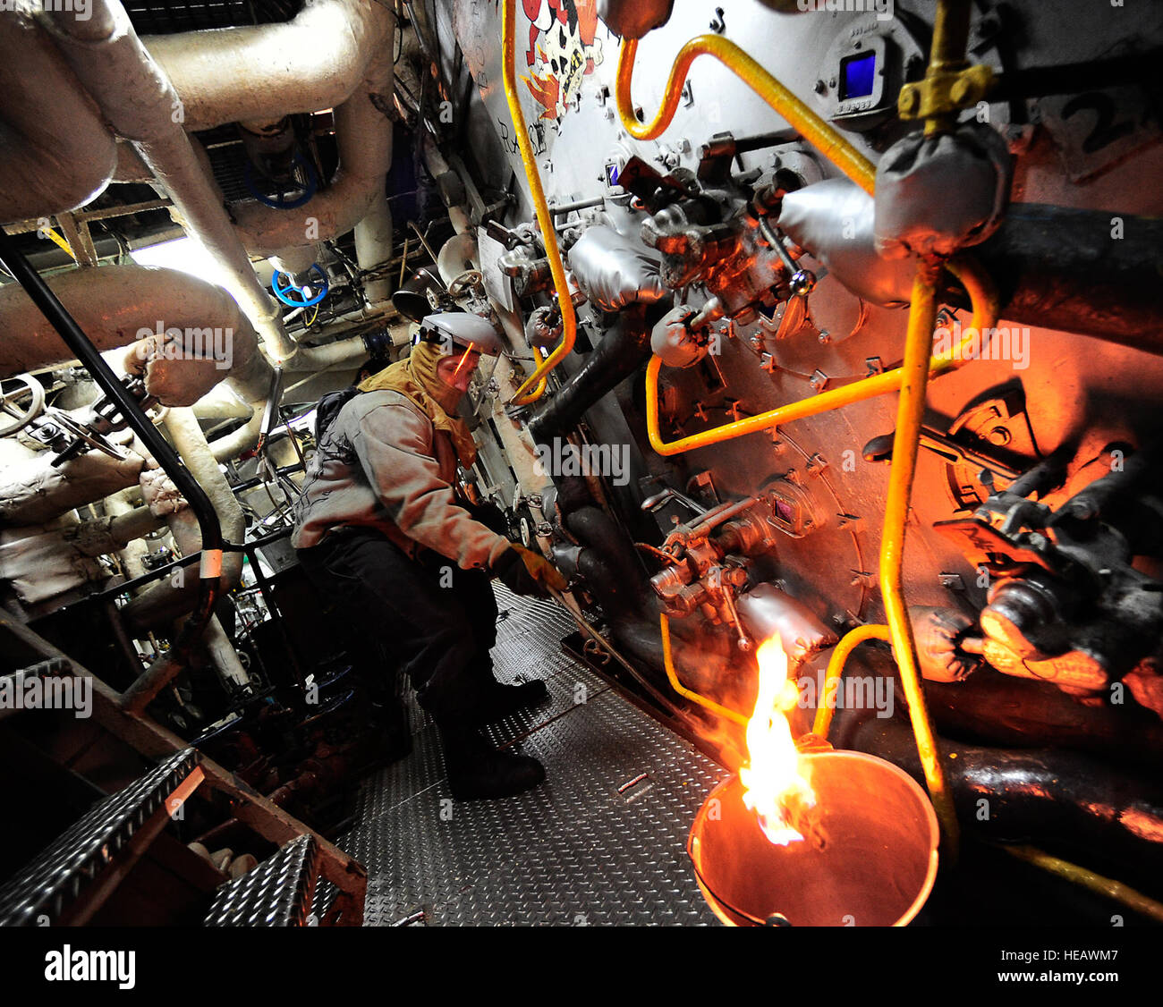 Seaman Zach Pierce holds a burning torch to demonstrate lighting the ...