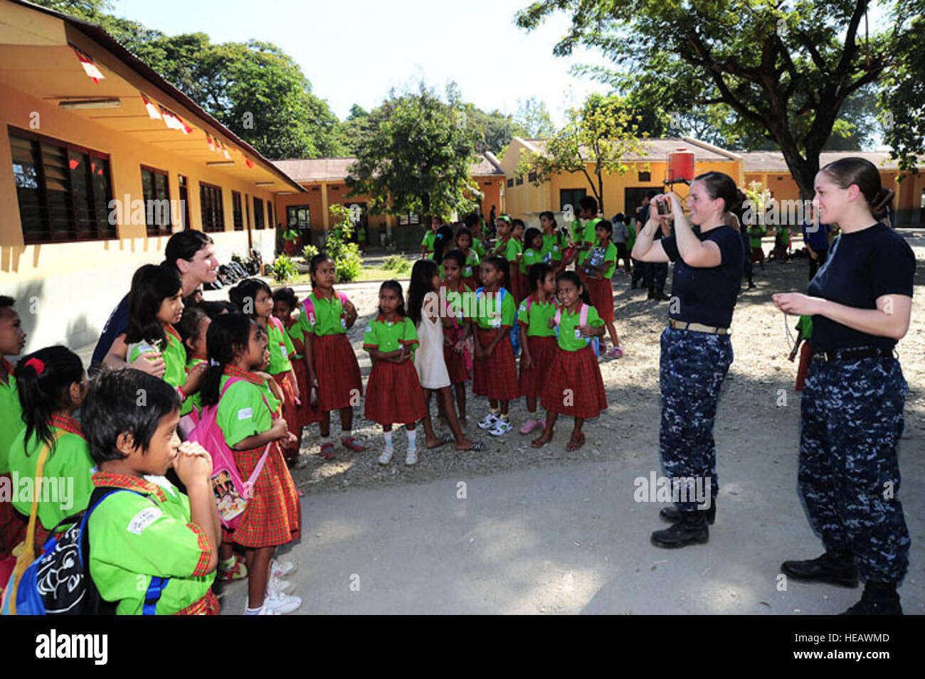 Ensign Allison Luzwick takes a photograph of Project HOPE volunteer ...