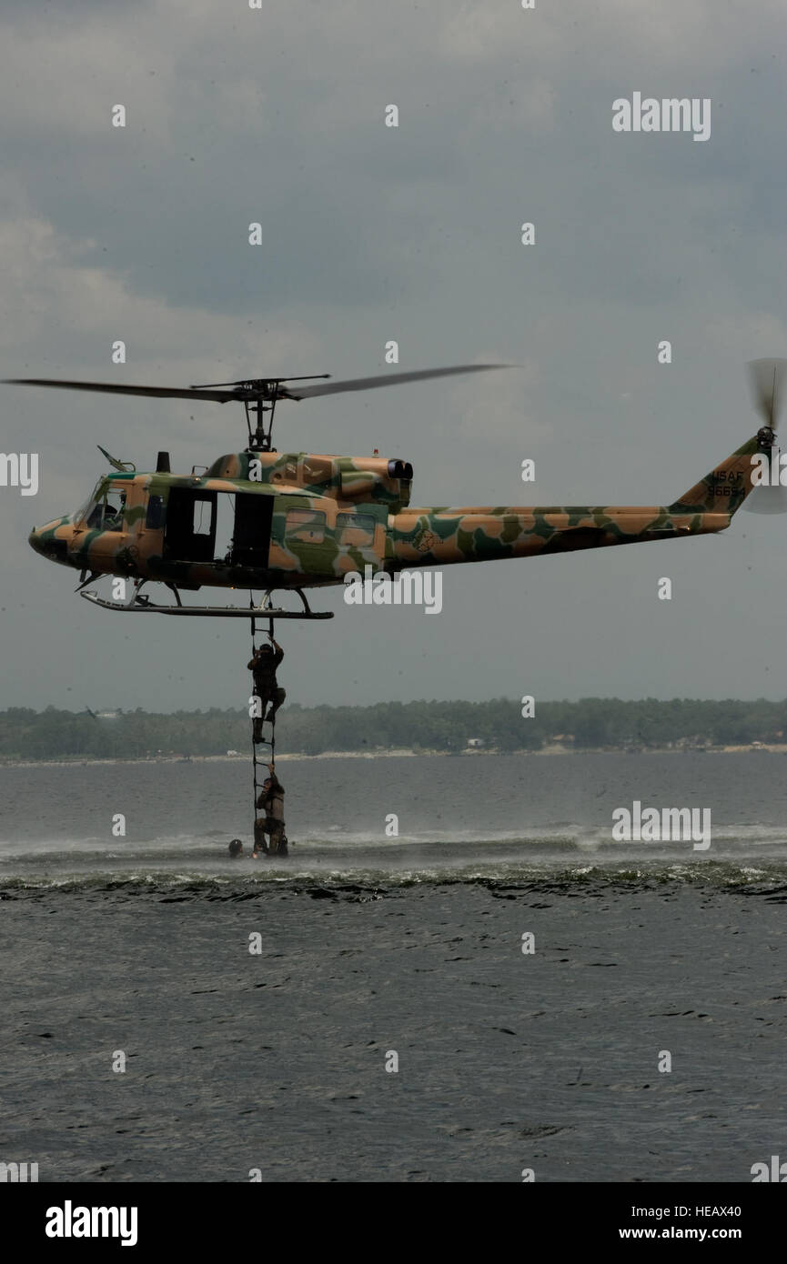 Pararescuemen of 23rd Special Tactics Squadron climb up a rope ladder ...