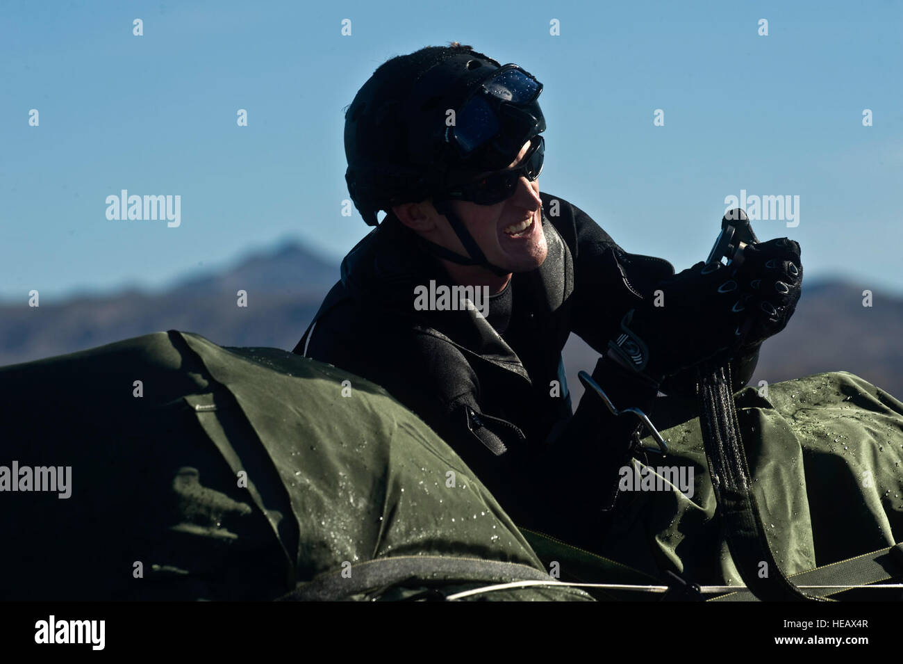 A U.S. Air Force pararescueman, 58th Rescue Squadron, takes straps off ...