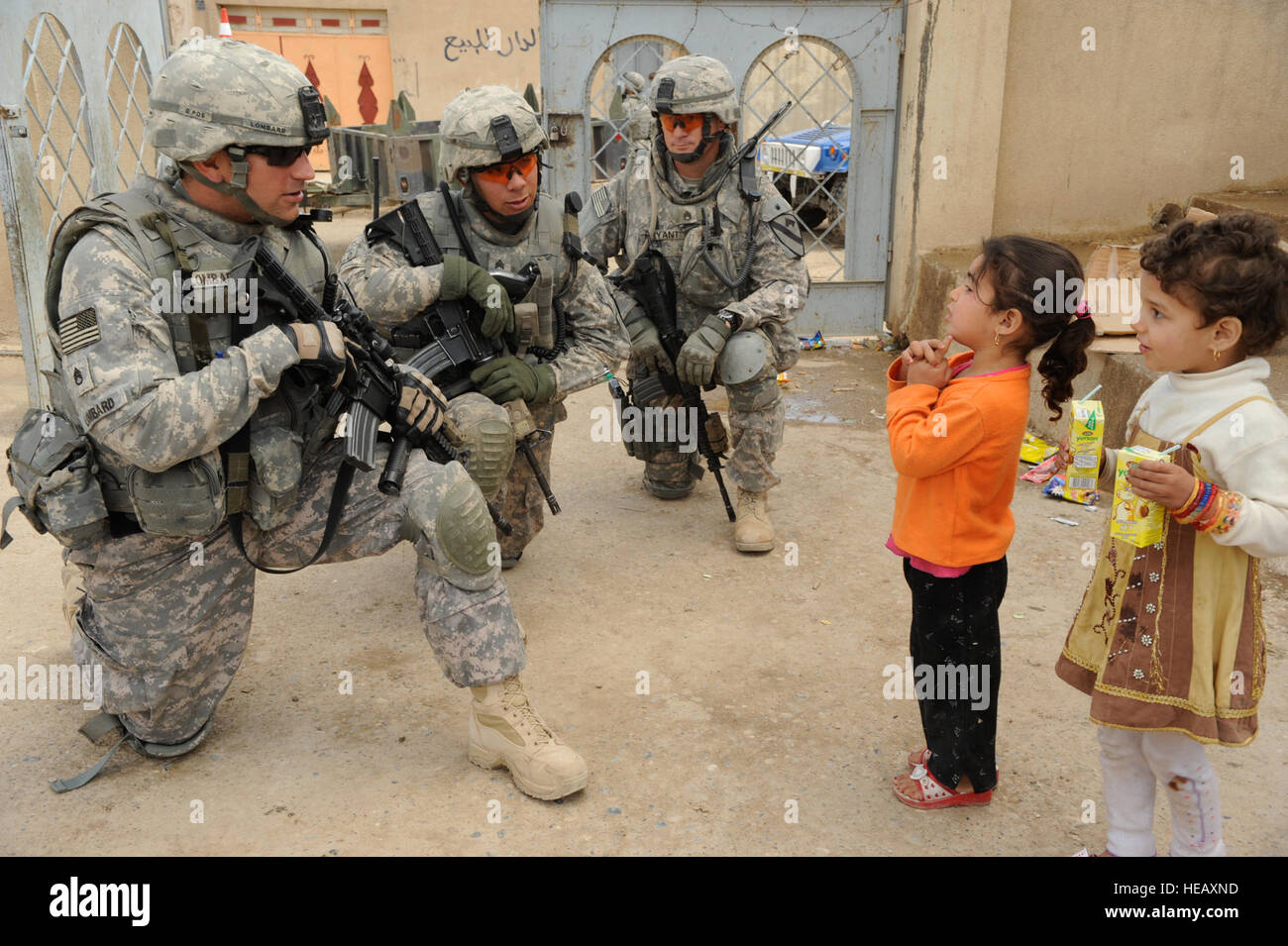 Two Iraqi girls entertain U.S. Army Staff Sgt. Nicholas Lombard, Sgt ...