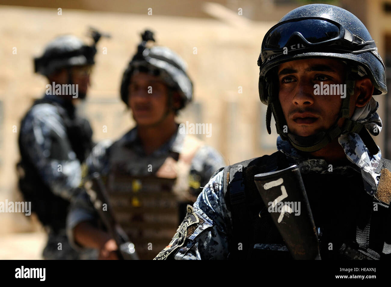 Iraqi police officers stand guard during a cordon and search mission in ...